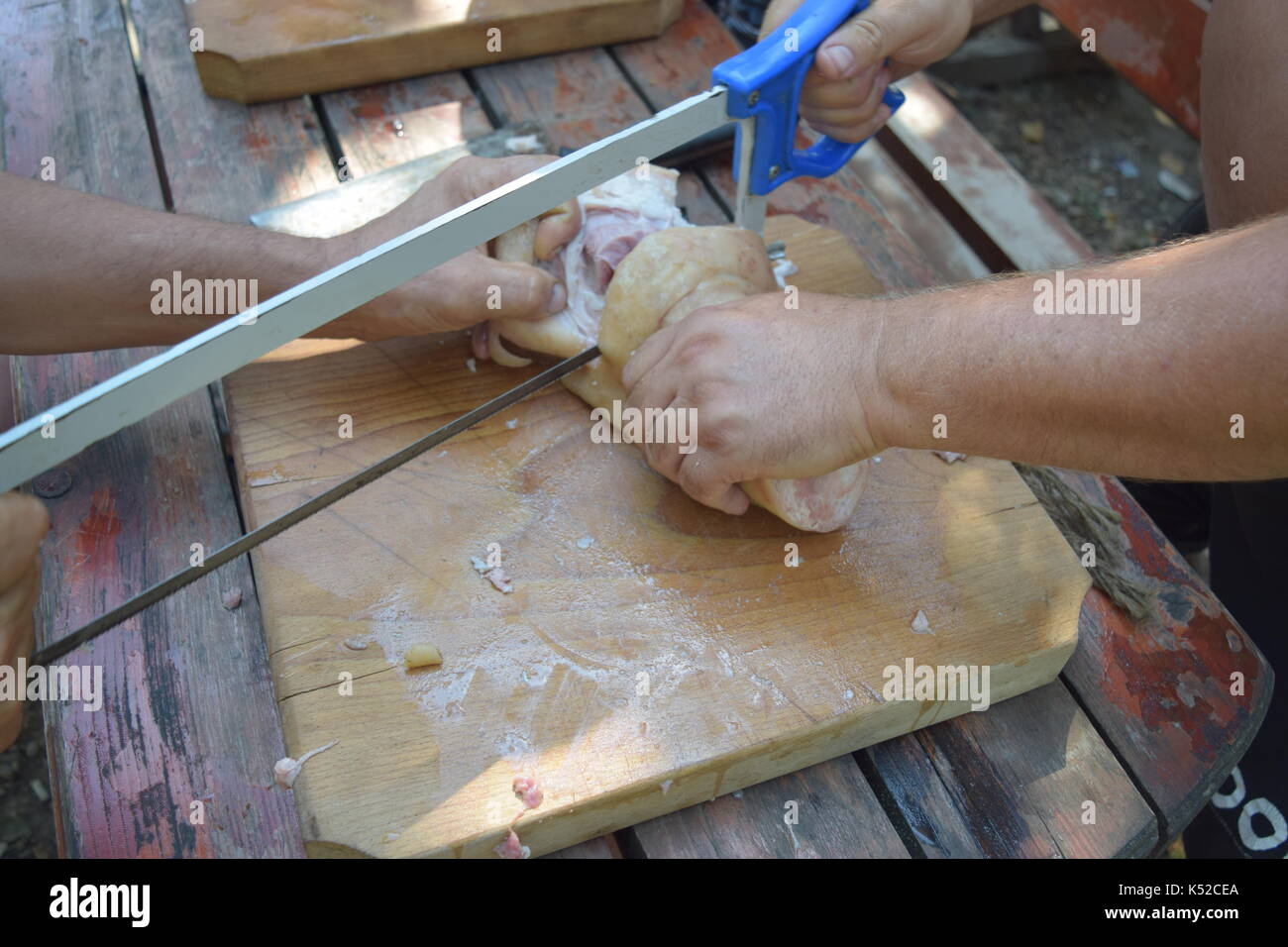 Close up of male hands chopping raw pork on a wooden board Stock Photo ...