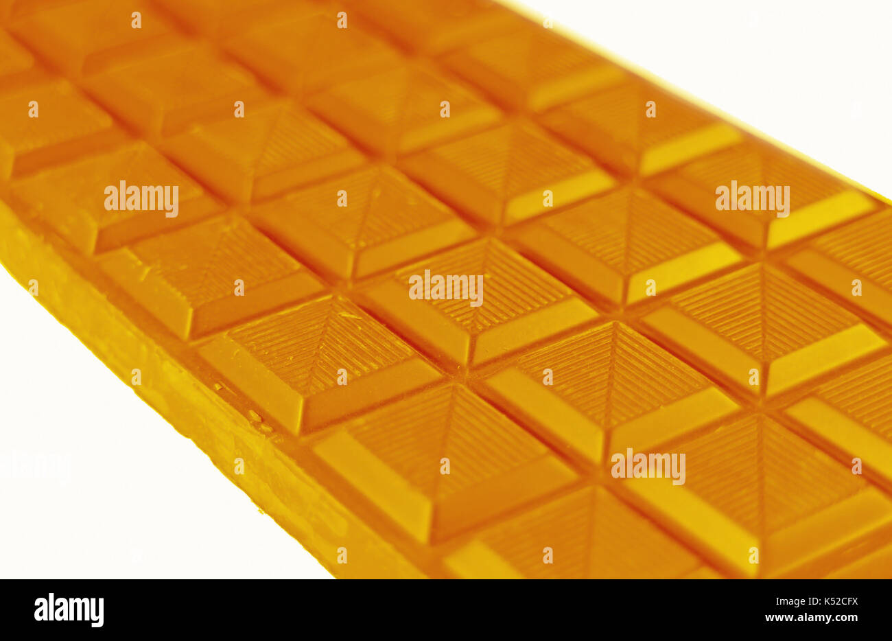 Close-up of Chocolate Bar in Honey Yellow Color Isolated on White ...