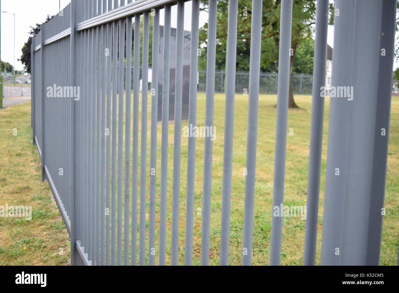 Side perspective of a silver park railing Stock Photo - Alamy