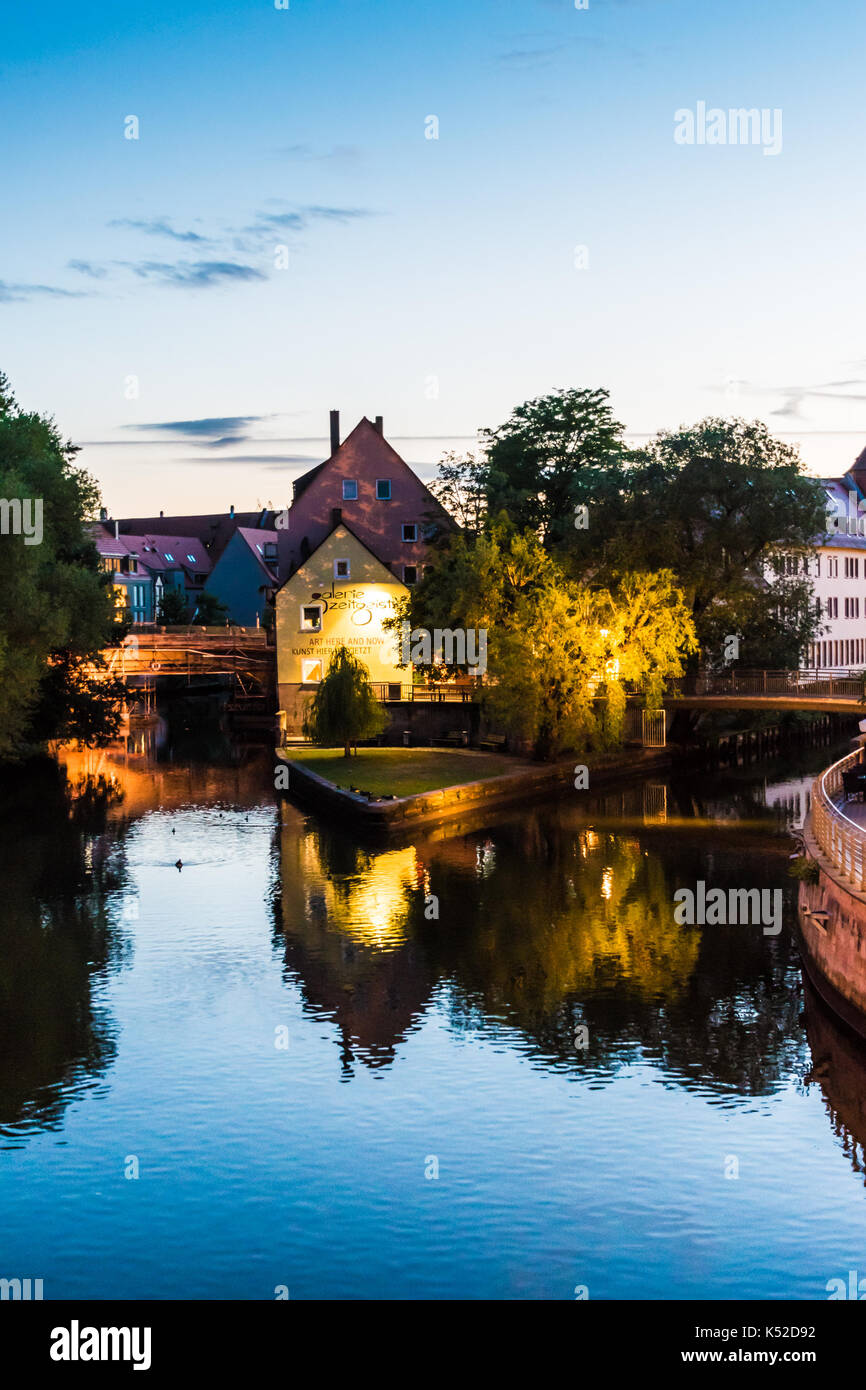 Reflection of old mill in water at sunset Stock Photo - Alamy