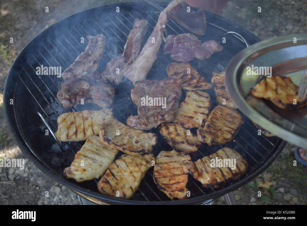 Fresh meat cooking on a barbecue Stock Photo - Alamy