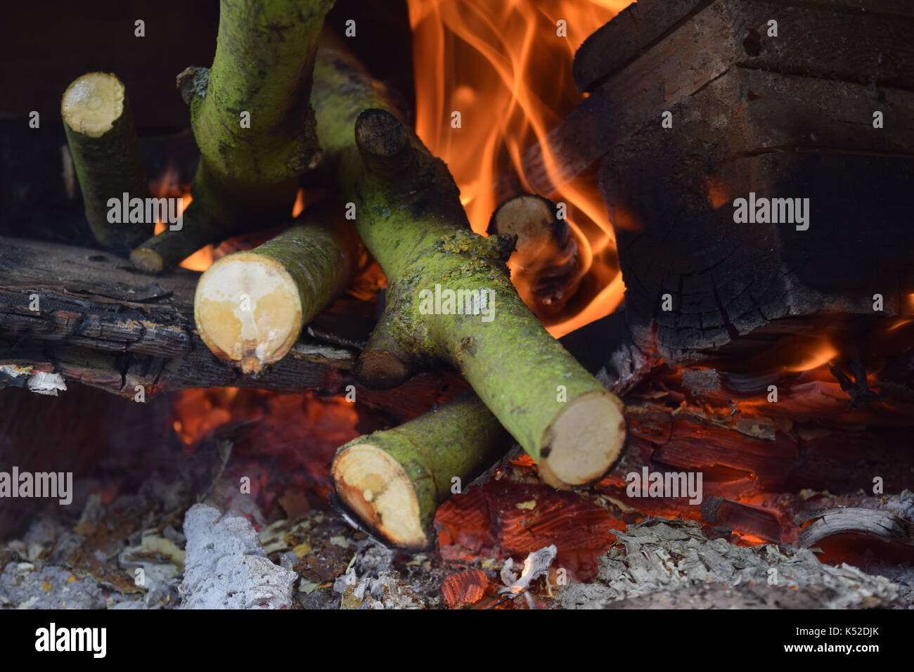 Fire wood burning in an outdoor fireplace Stock Photo - Alamy