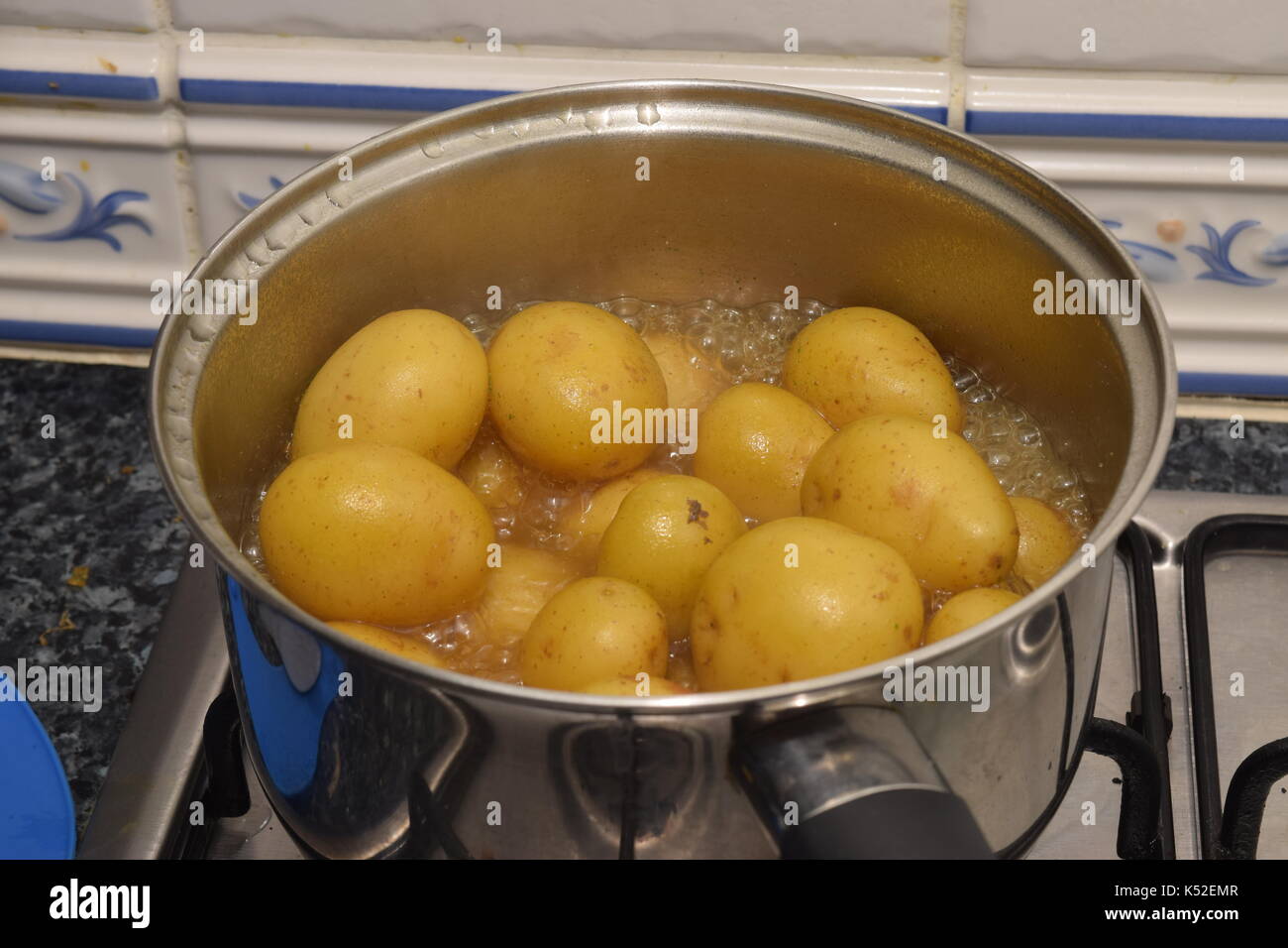 Organic white potatoes boiling in a pot Stock Photo - Alamy
