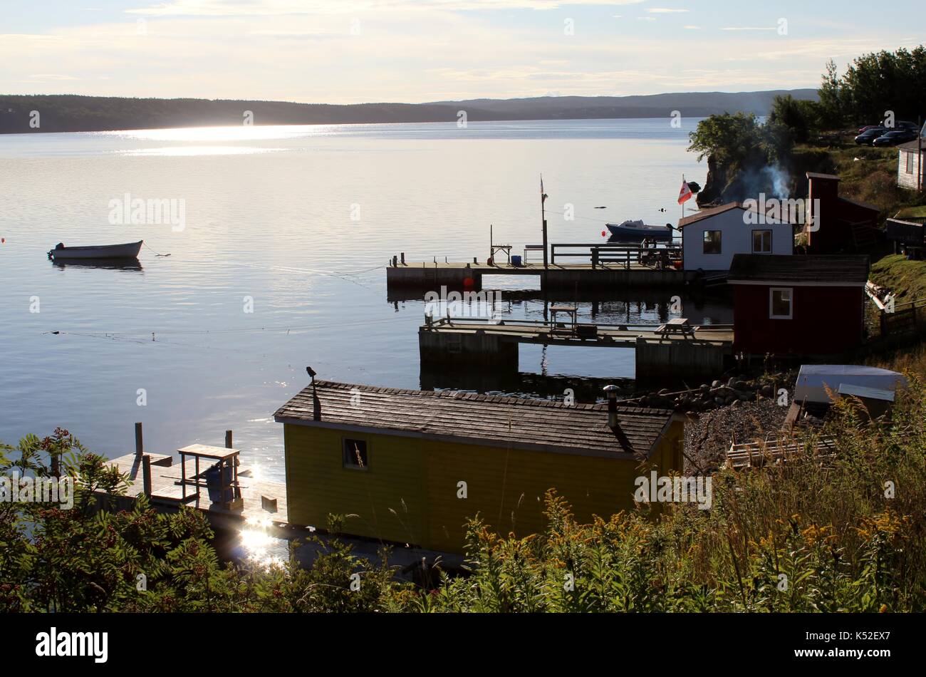 Small fishing village with row boat and wharf and docks Stock Photo - Alamy