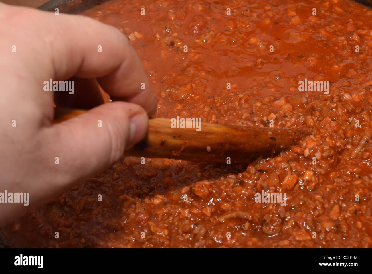Male hand stirring mince meat cooking with a wooden spoon Stock Photo ...