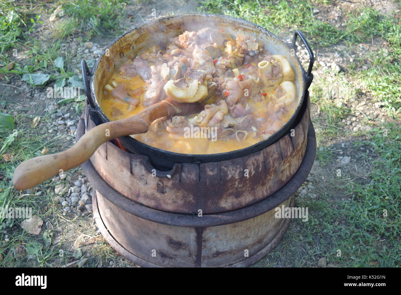 Lamb stew cooking in a large metal pot outdoors Stock Photo - Alamy