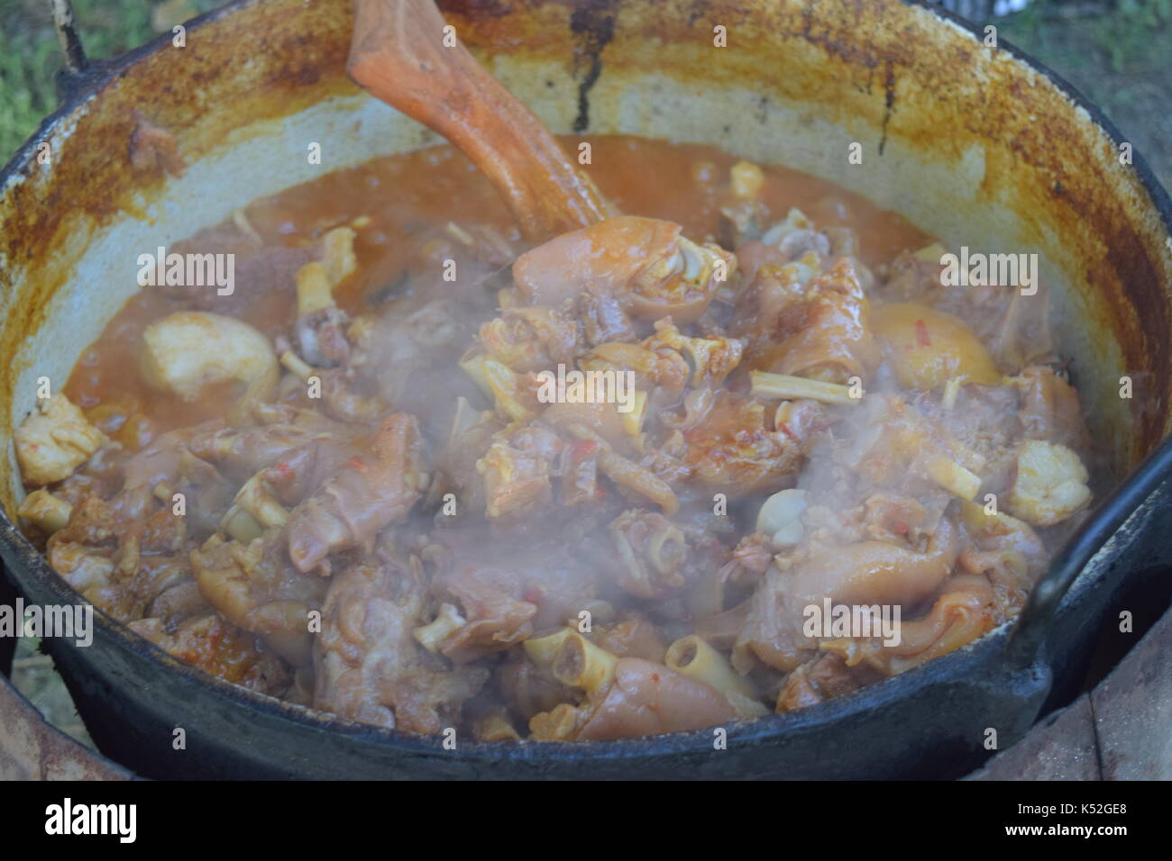 Wooden spoon mixing a larger pot of stew Stock Photo - Alamy