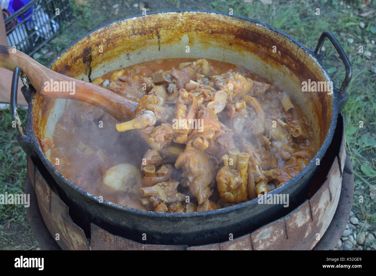 Wooden spoon mixing a larger pot of stew Stock Photo - Alamy