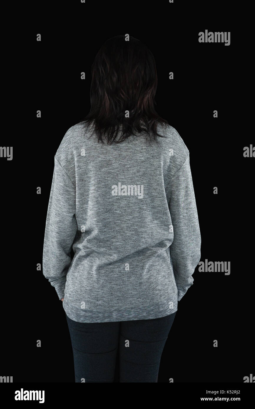Rear view of woman standing on black background Stock Photo - Alamy