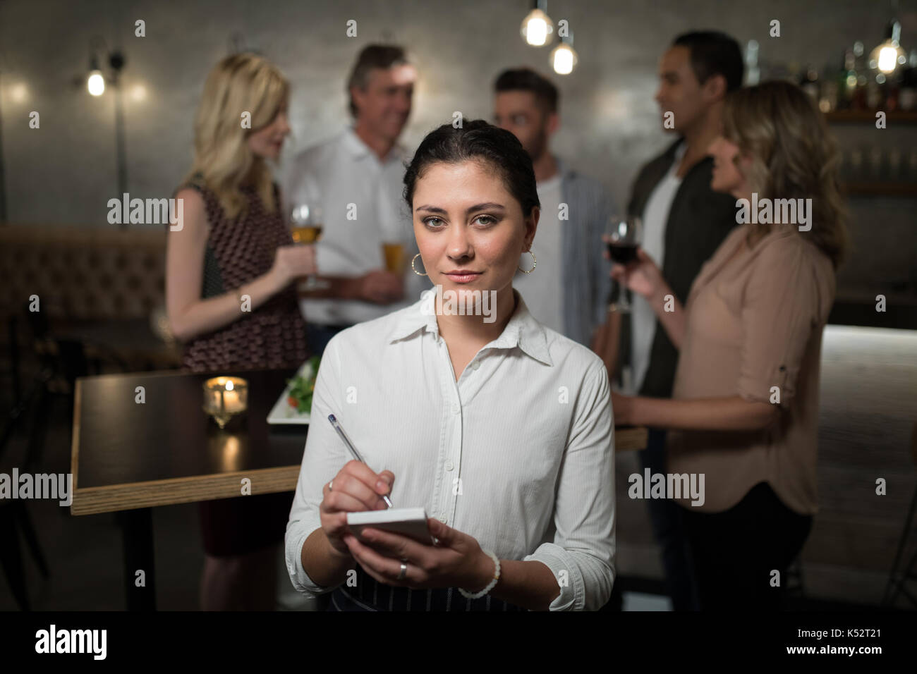 Portrait of beautiful waitress writing order in notepad Stock Photo - Alamy