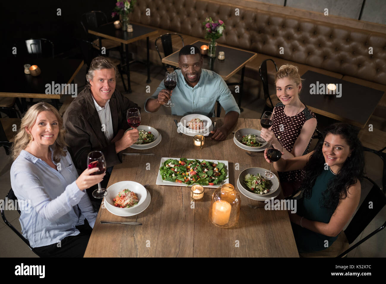 Overhead of happy friends dining together in restaurant Stock Photo - Alamy