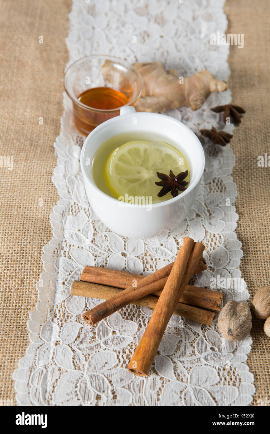 Cinnamons with ginger tea cup and honey on burlap Stock Photo - Alamy