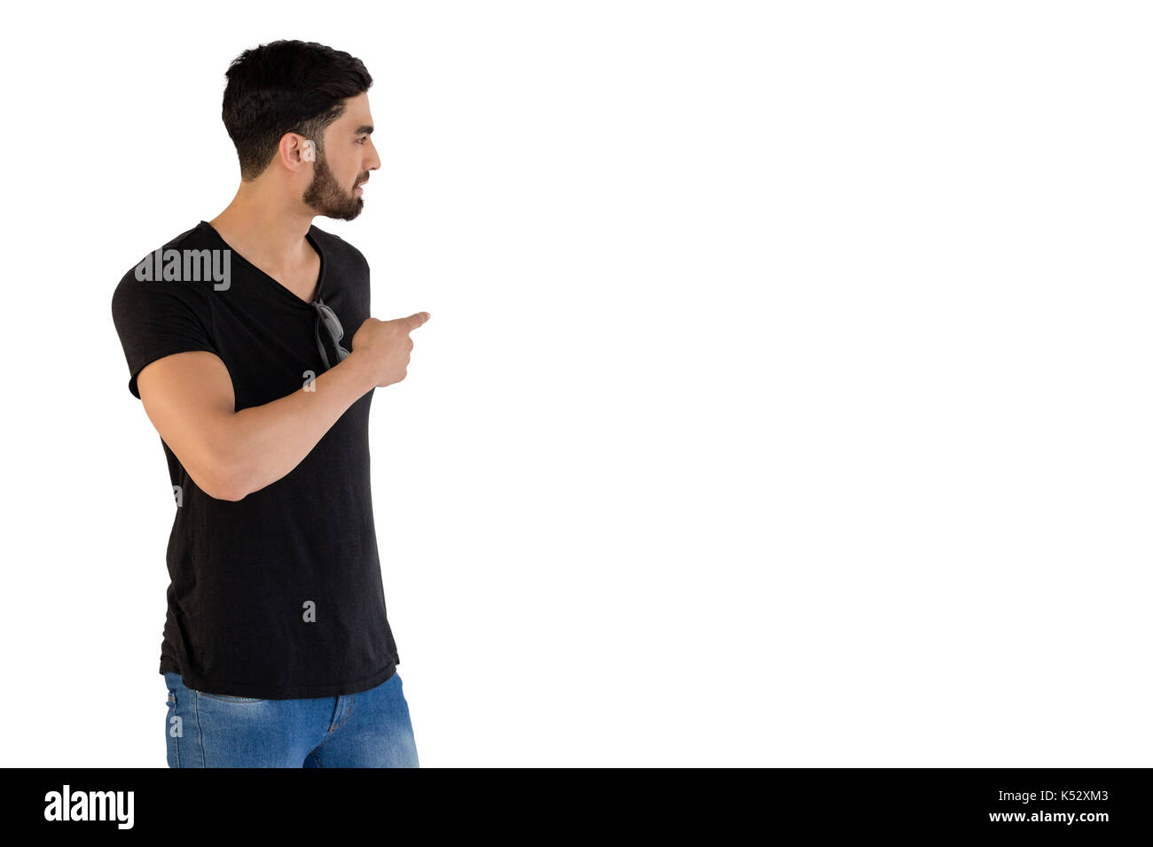 Handsome man pointing at white background Stock Photo - Alamy