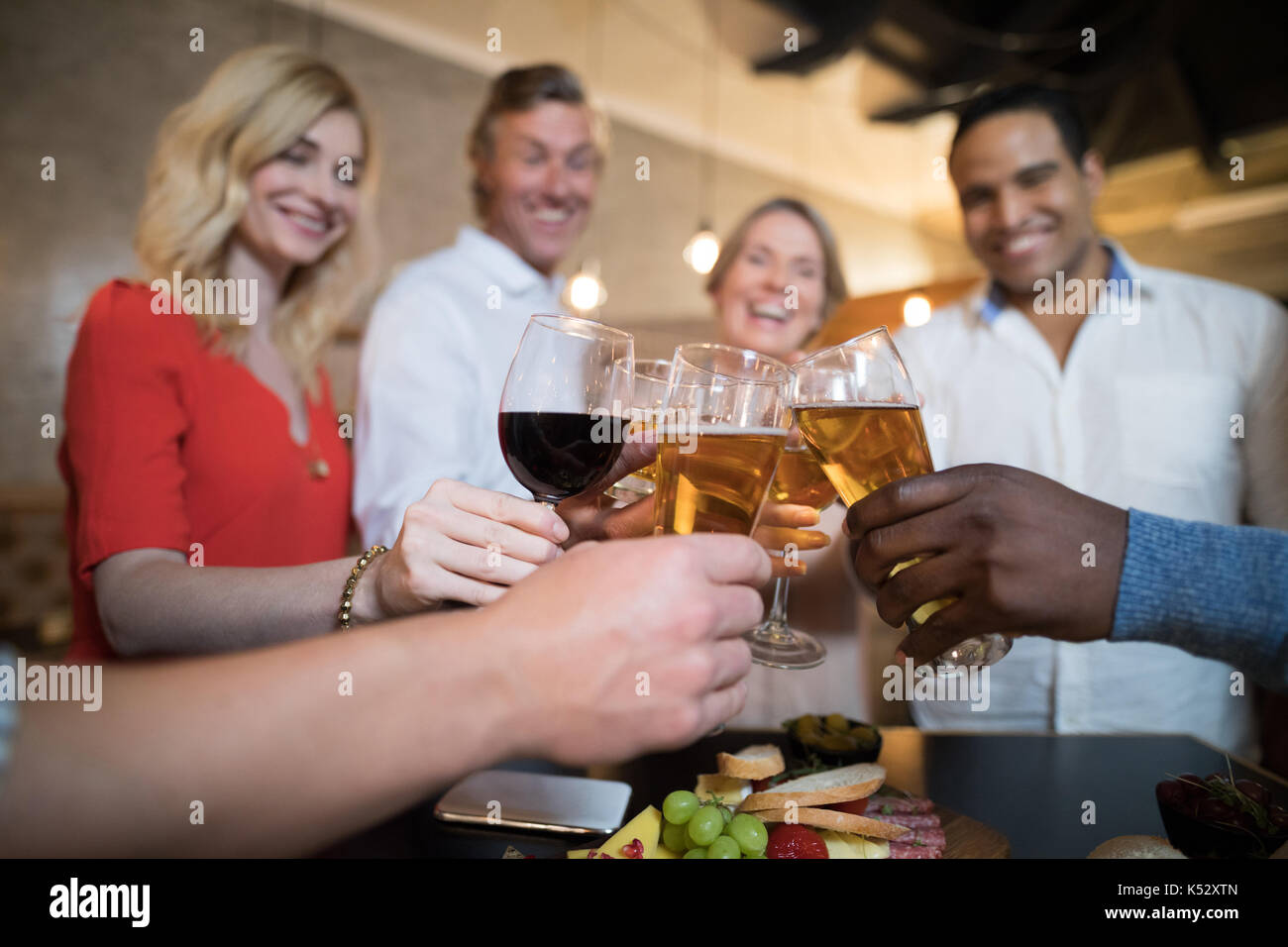 Smiling friends toasting whisky glass hi-res stock photography and ...