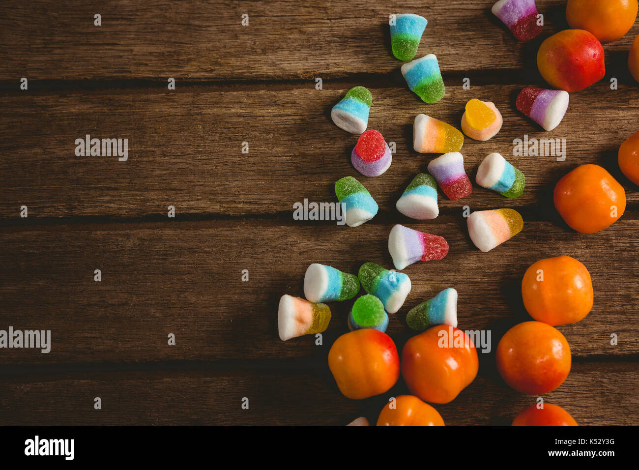 Overhead view of colorful sweet food on wooden table Stock Photo - Alamy