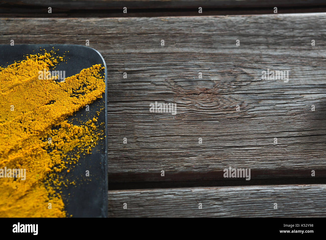 Close-up of turmeric powder on board Stock Photo - Alamy