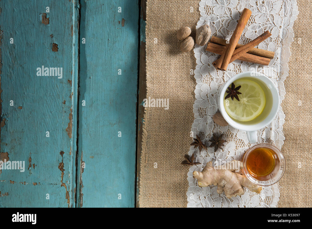 Overhead view of cinnamons with ginger tea on burlap over wooden table ...