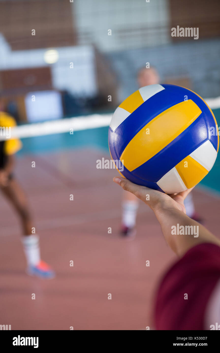 Female volleyball player playing volleyball in the court Stock Photo ...