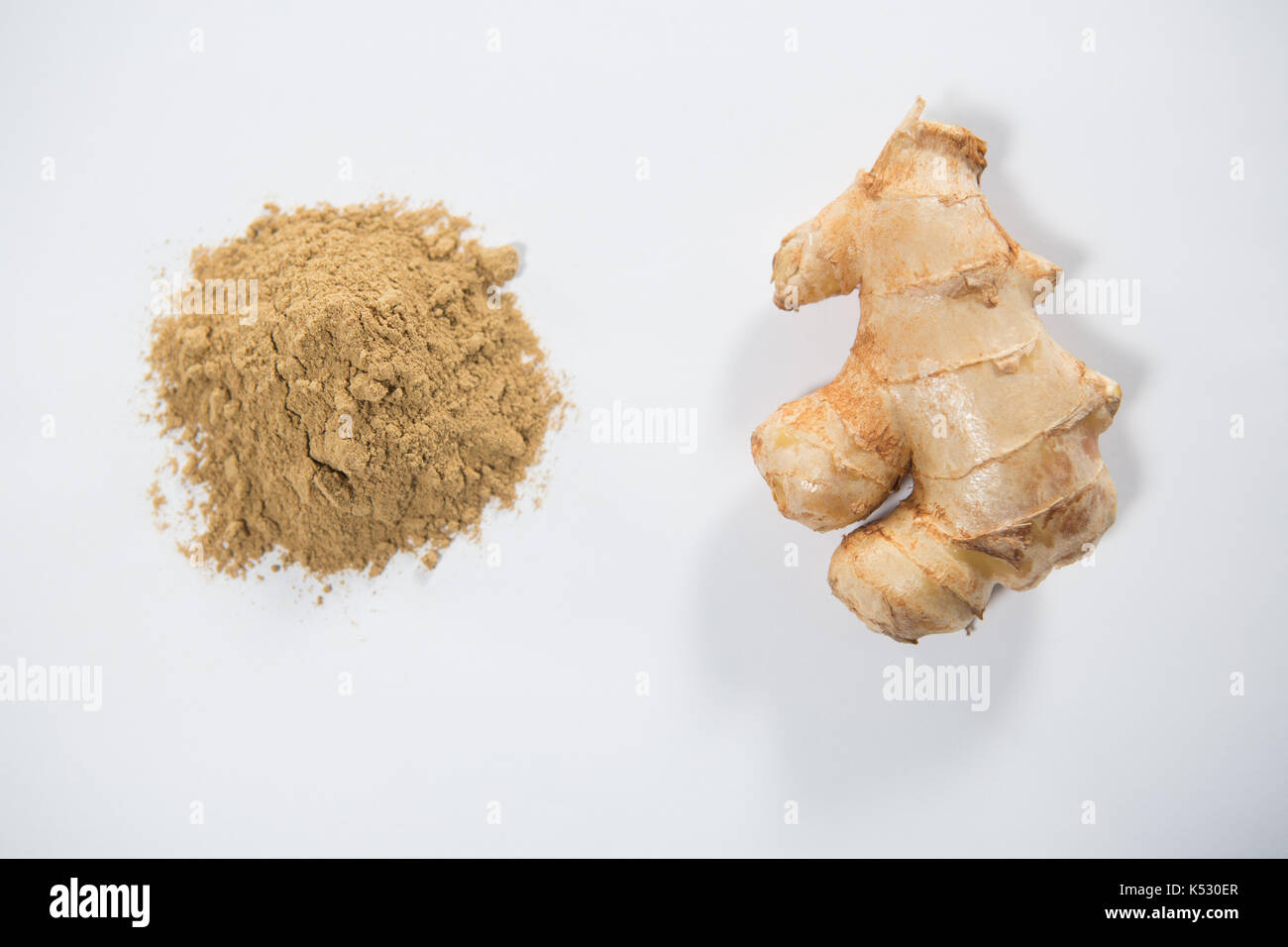 Overhead view of fresh ginger and powder on white background Stock ...