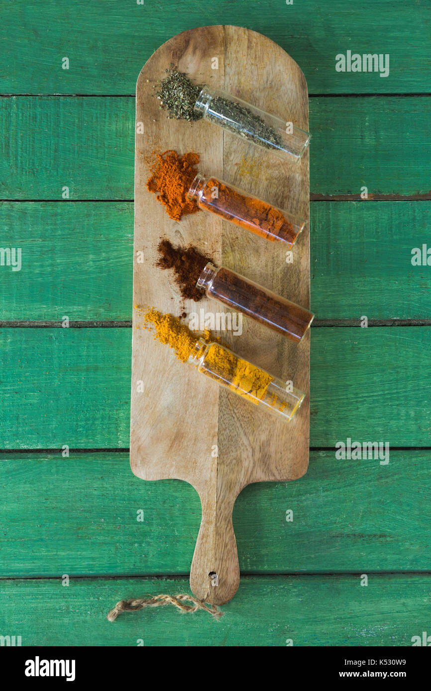 Overhead of various spices spilling out of bottles Stock Photo - Alamy
