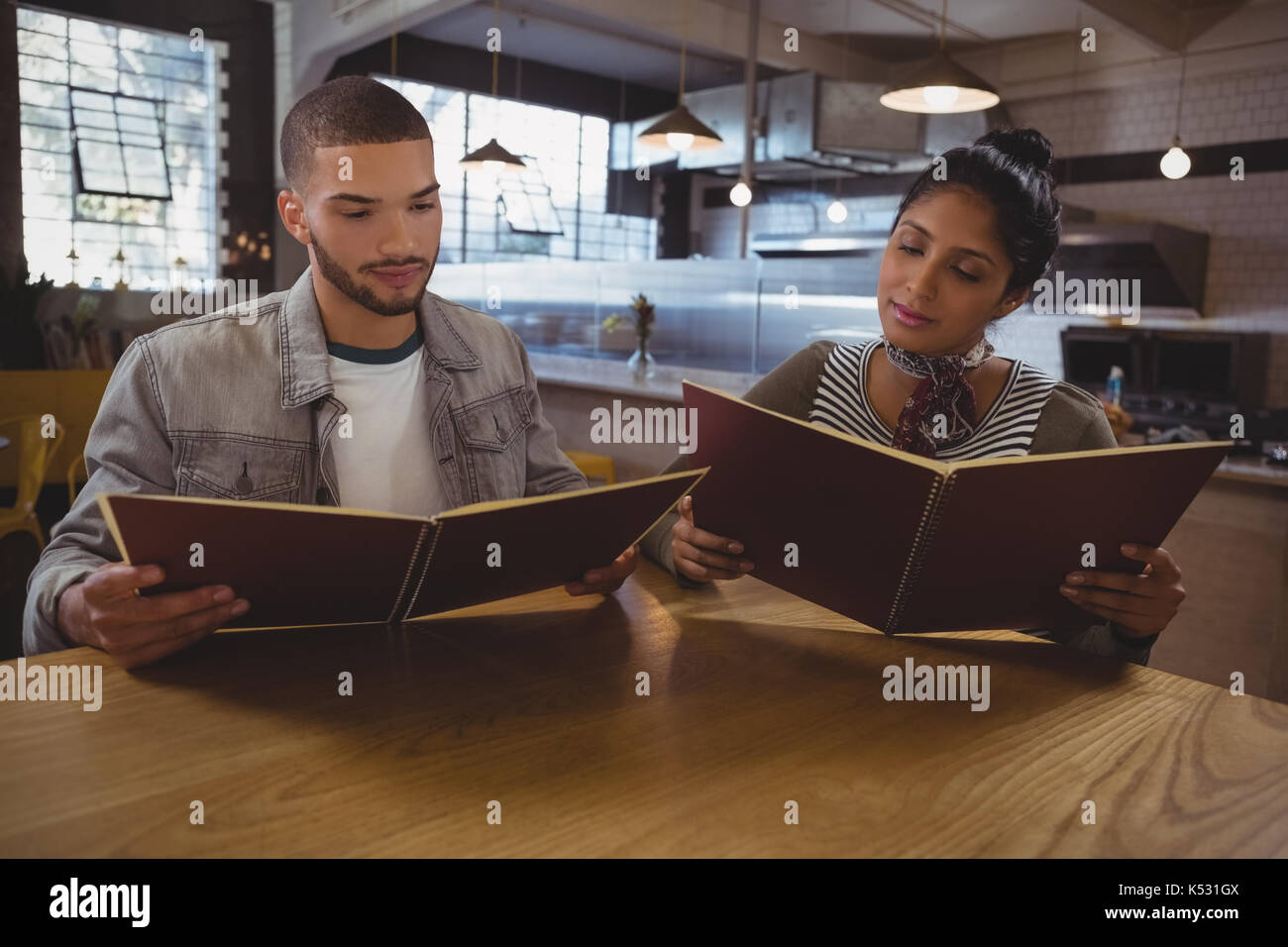 Smiling friends discussing menu hi-res stock photography and images - Alamy