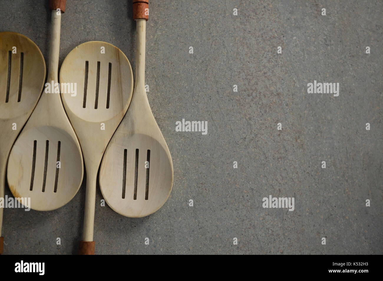 Overhead view of spatulas arranged side by side on table Stock Photo ...