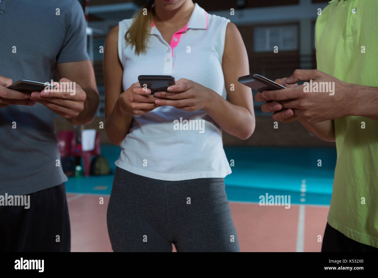 Female players using mobile phone hi-res stock photography and images ...