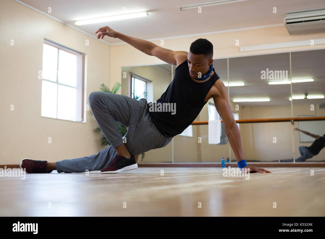 Full length of male dancer practicing on wooden floor at studio Stock ...