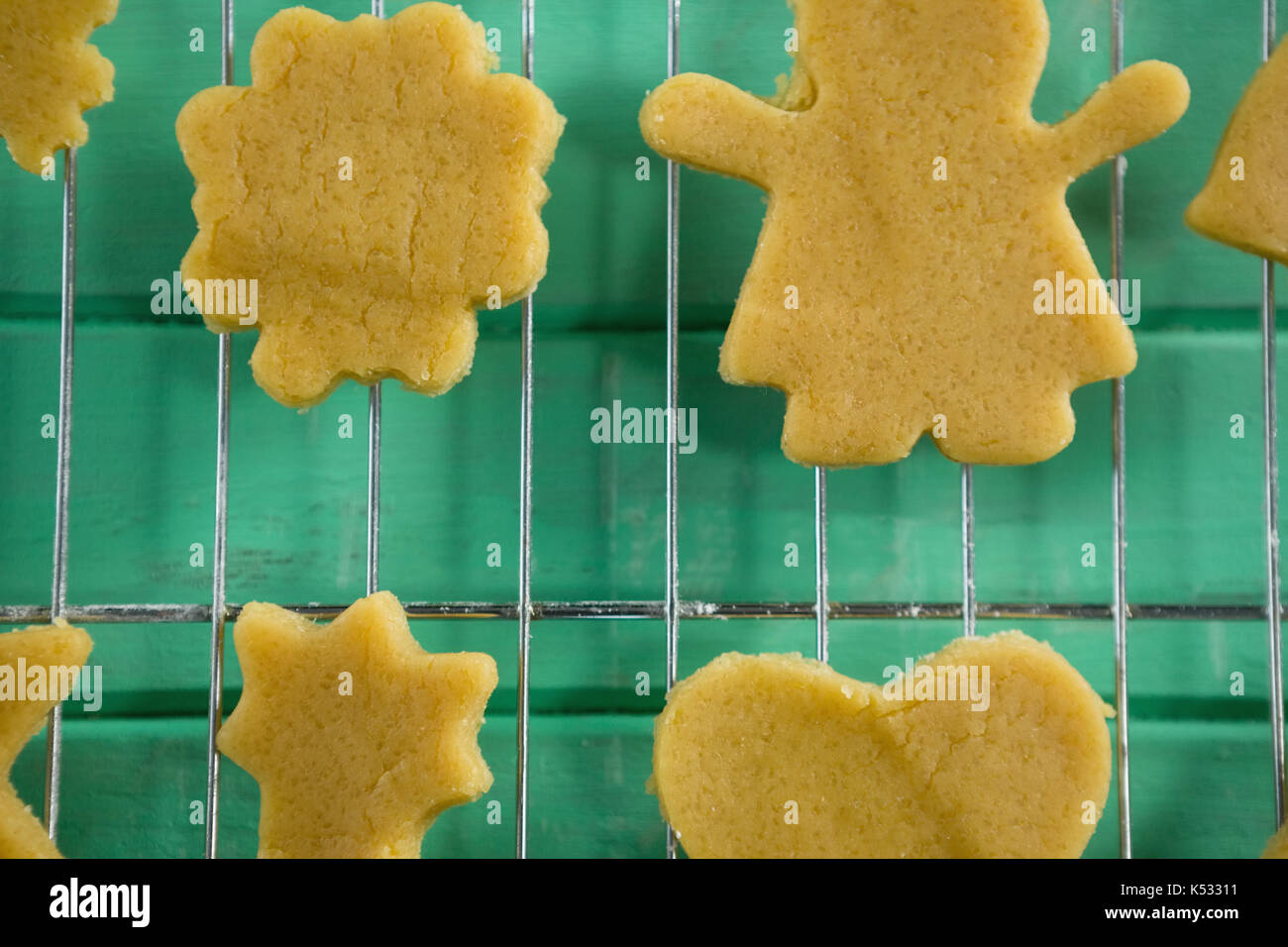 Cookies on cooling rack at wooden table Stock Photo - Alamy