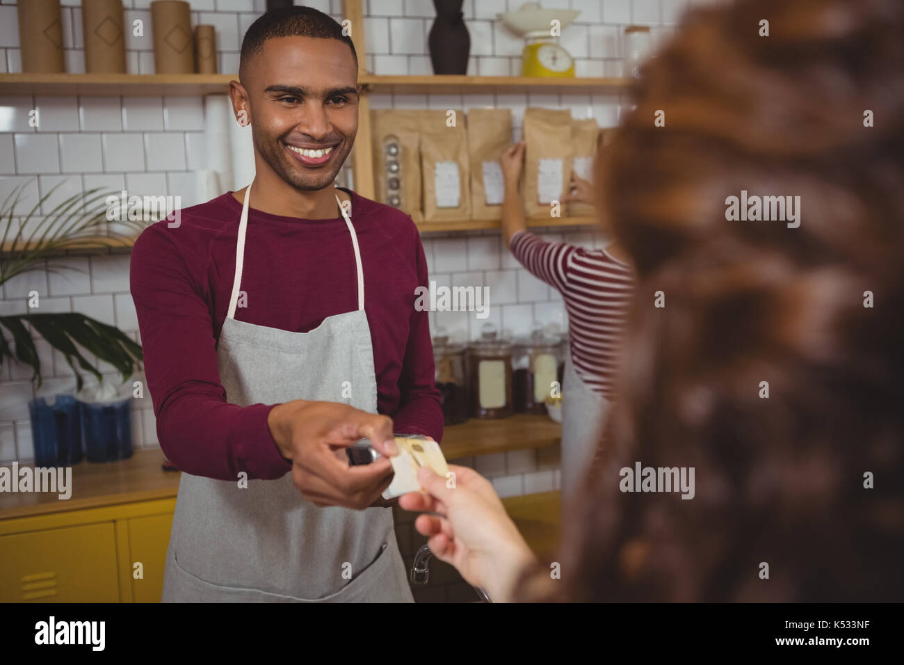 Business owner taking payment from hi-res stock photography and images ...