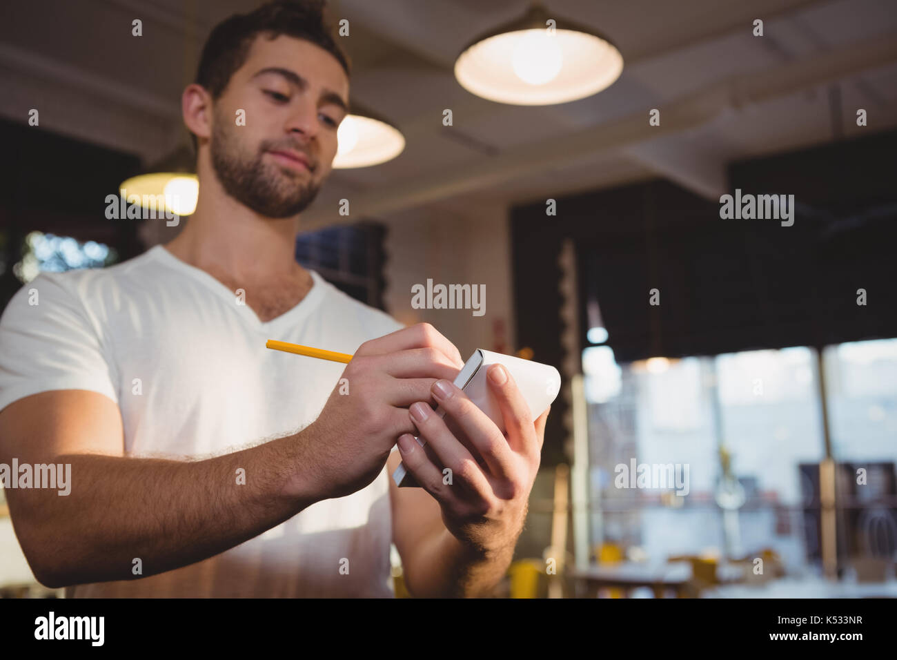 Young waiter taking order in cafe Stock Photo - Alamy