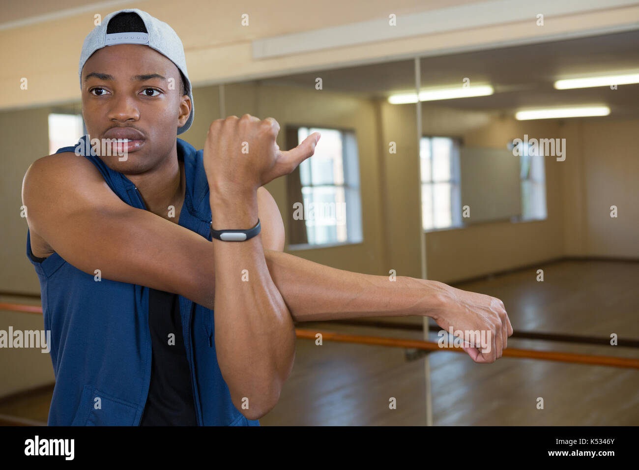 Male dancer looking away while warming up at studio Stock Photo - Alamy
