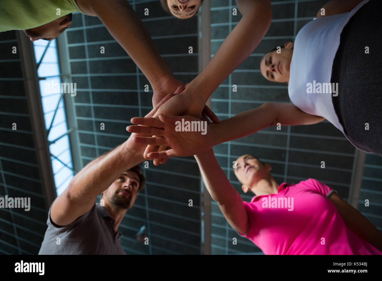 Low angle view of volleyball players stacking hands at court Stock ...
