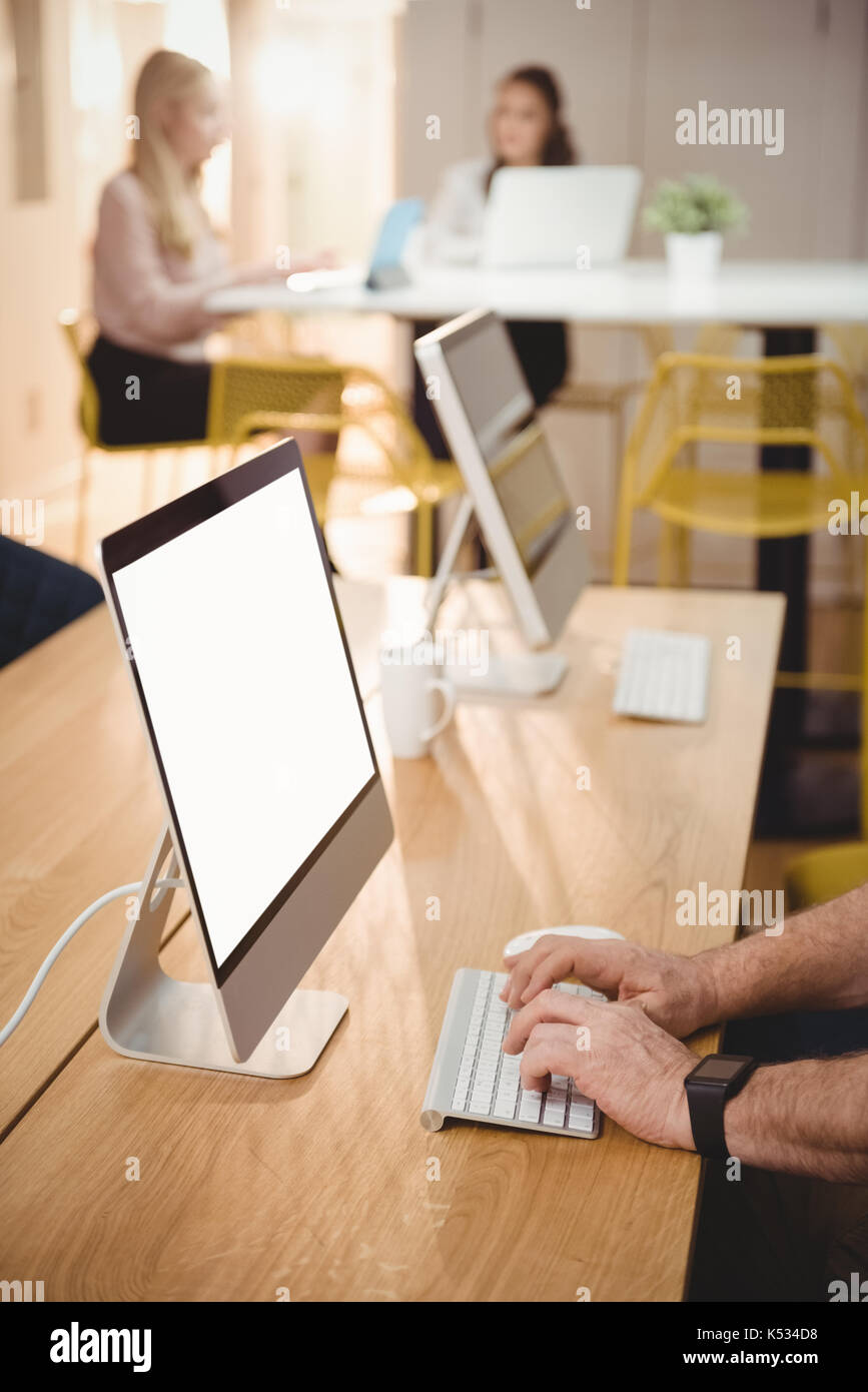 Male executive working on computer in office Stock Photo - Alamy