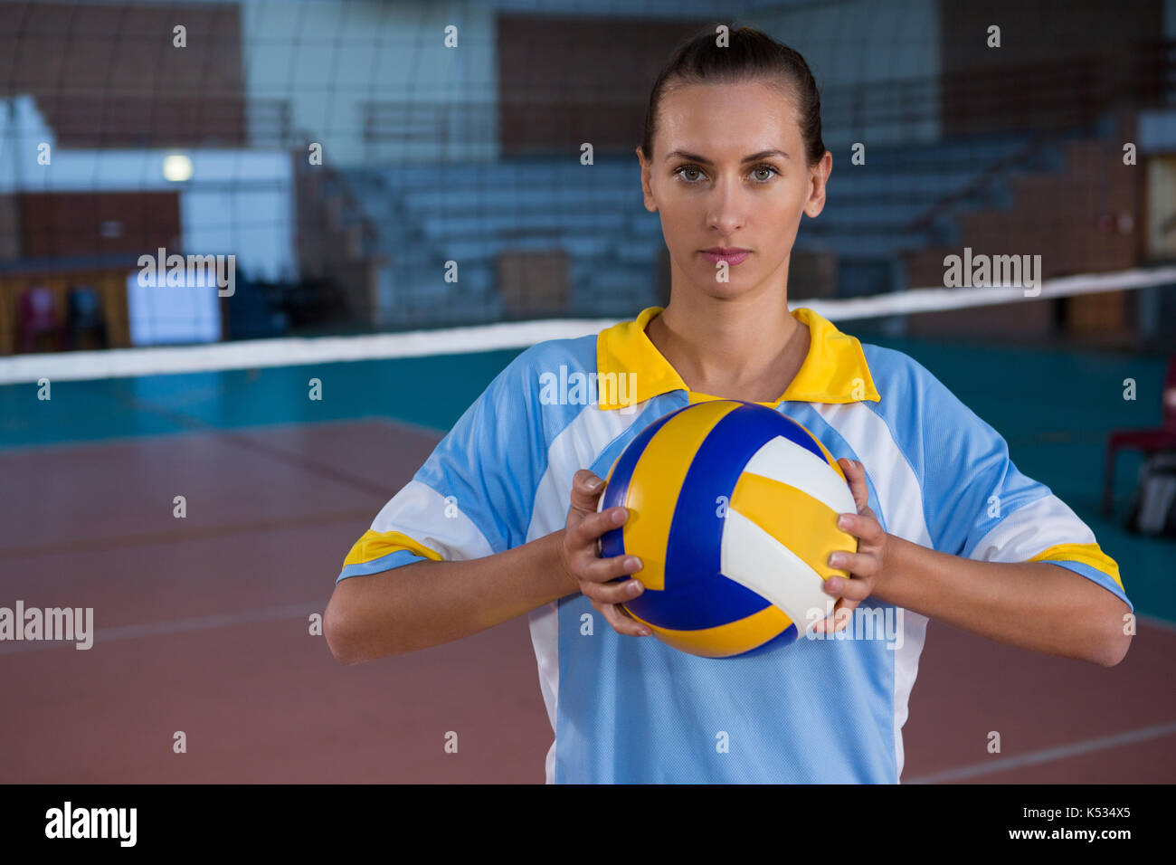 Portrait of young female sportsperson holding volleyball Stock Photo ...
