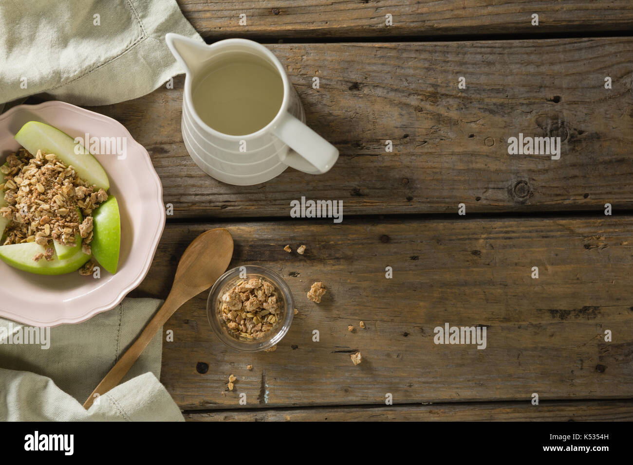 Plate of breakfast cereals with fruits and milk on wooden table Stock ...