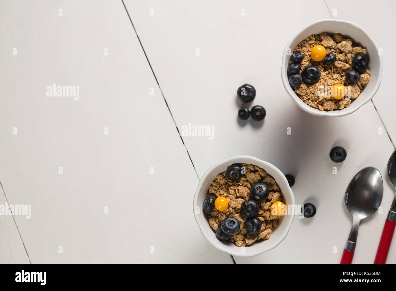 Bowl of breakfast cereals with spoon on white background Stock Photo ...