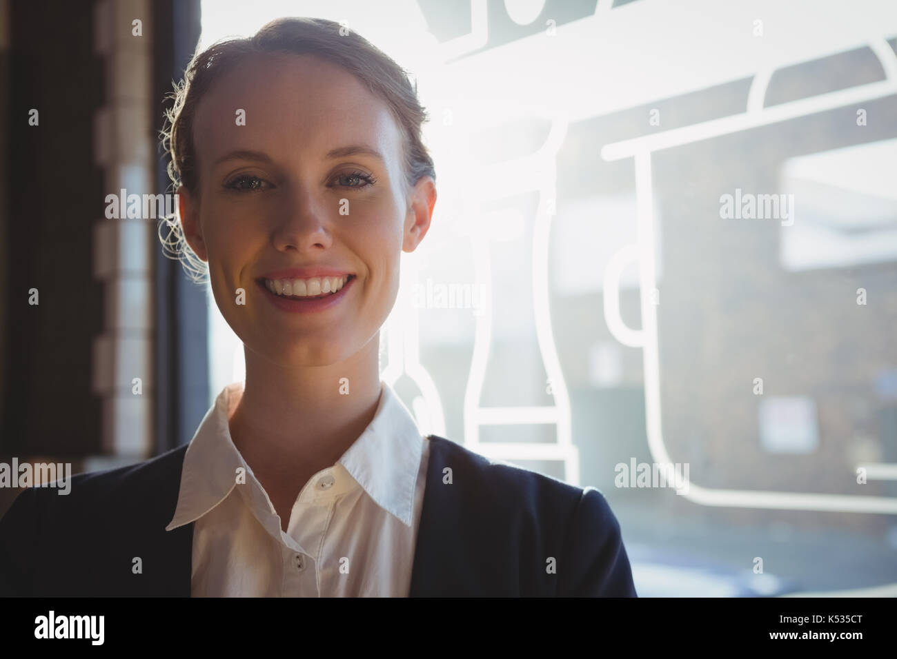 Portrait of happy female owner by window in cafe Stock Photo - Alamy