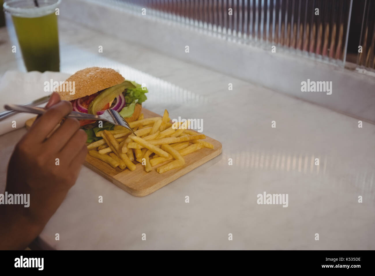 Hand holding french fries in hi-res stock photography and images - Alamy