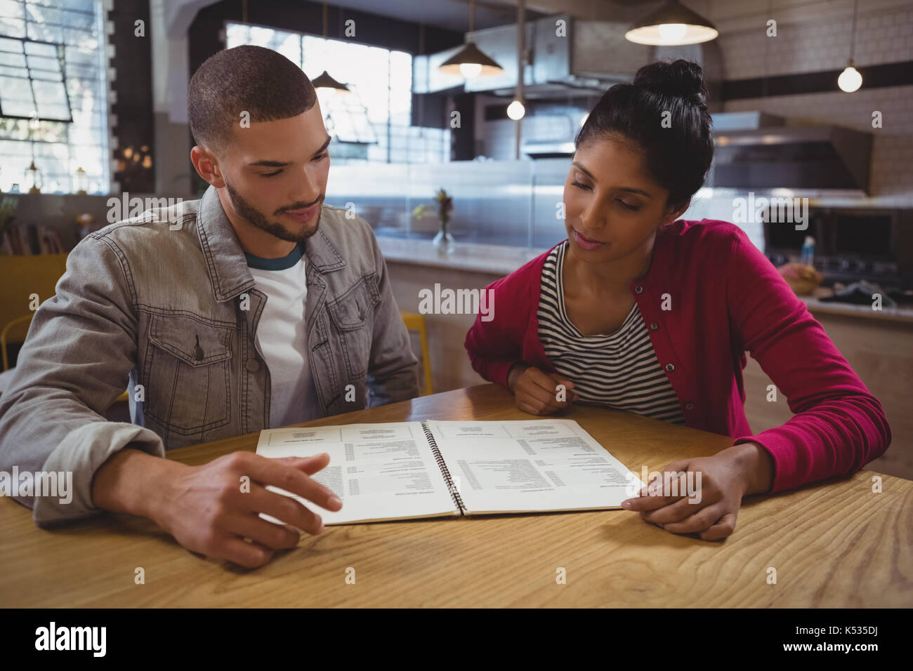 Smiling friends discussing menu hi-res stock photography and images - Alamy