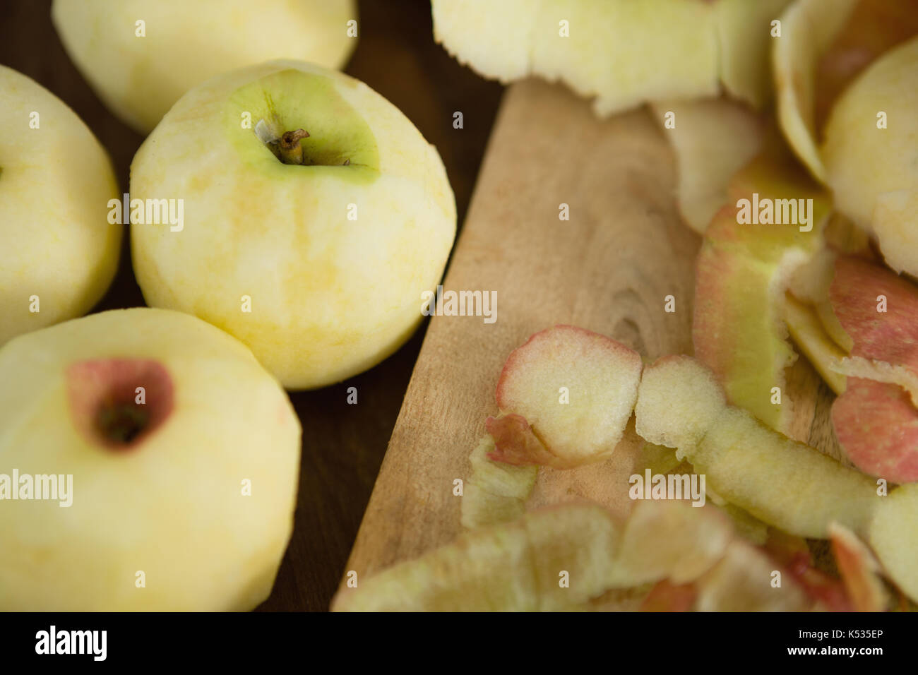 High angle view of apples by peels on cutting board Stock Photo - Alamy