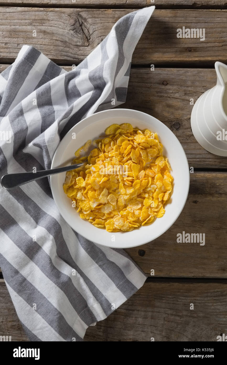 Bowl of wheaties cereal and spoon with napkin on wooden table Stock ...