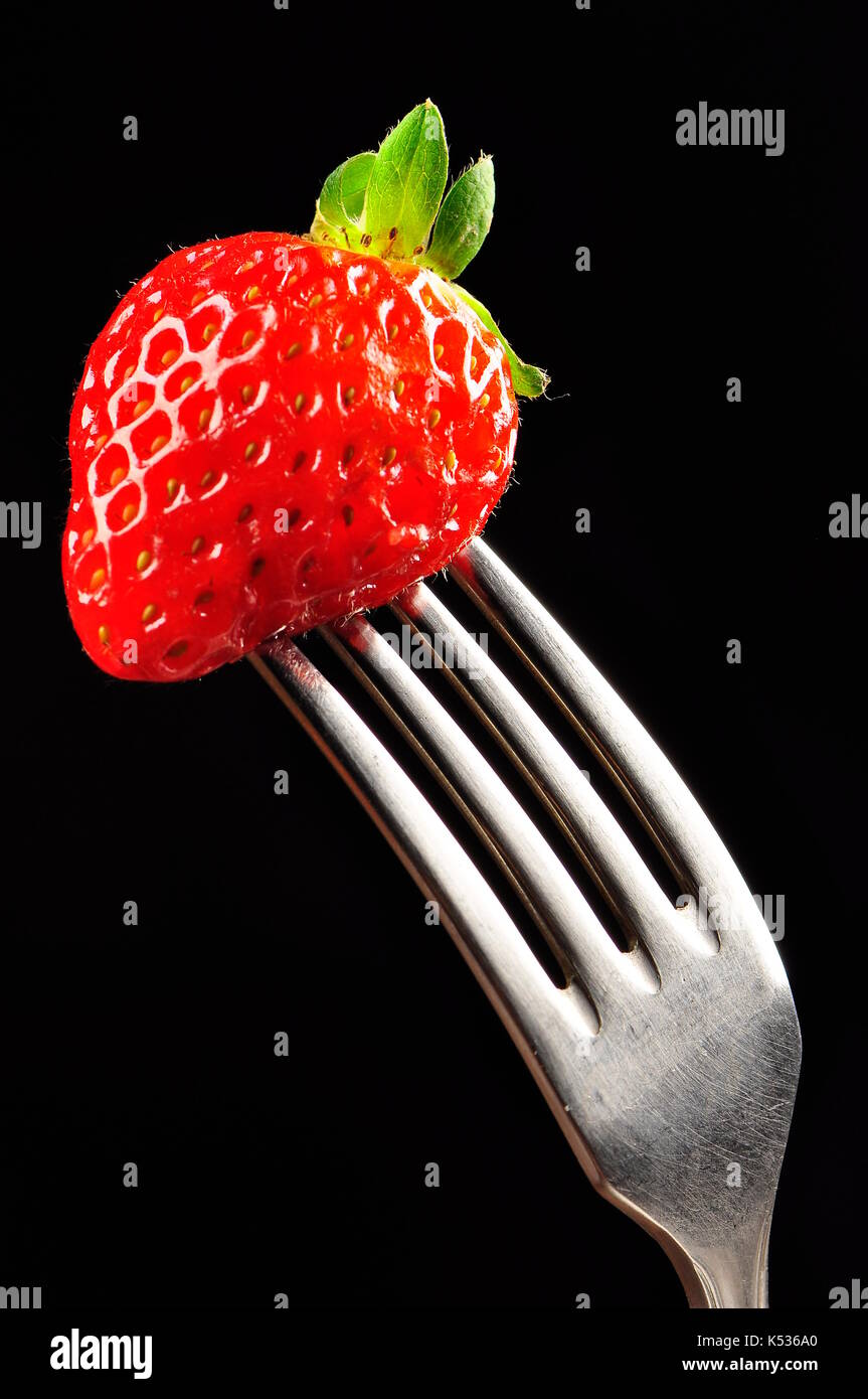 Strawberry on a fork concept Stock Photo - Alamy