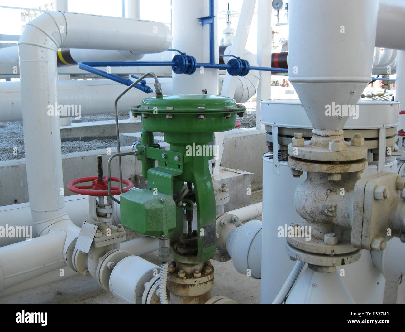Green pneumatic valve on the pipeline. The equipment of the oil plant ...