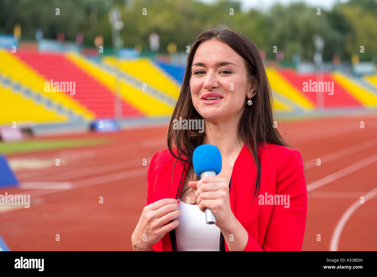 The journalist is reporting from the stadium for television Stock Photo ...