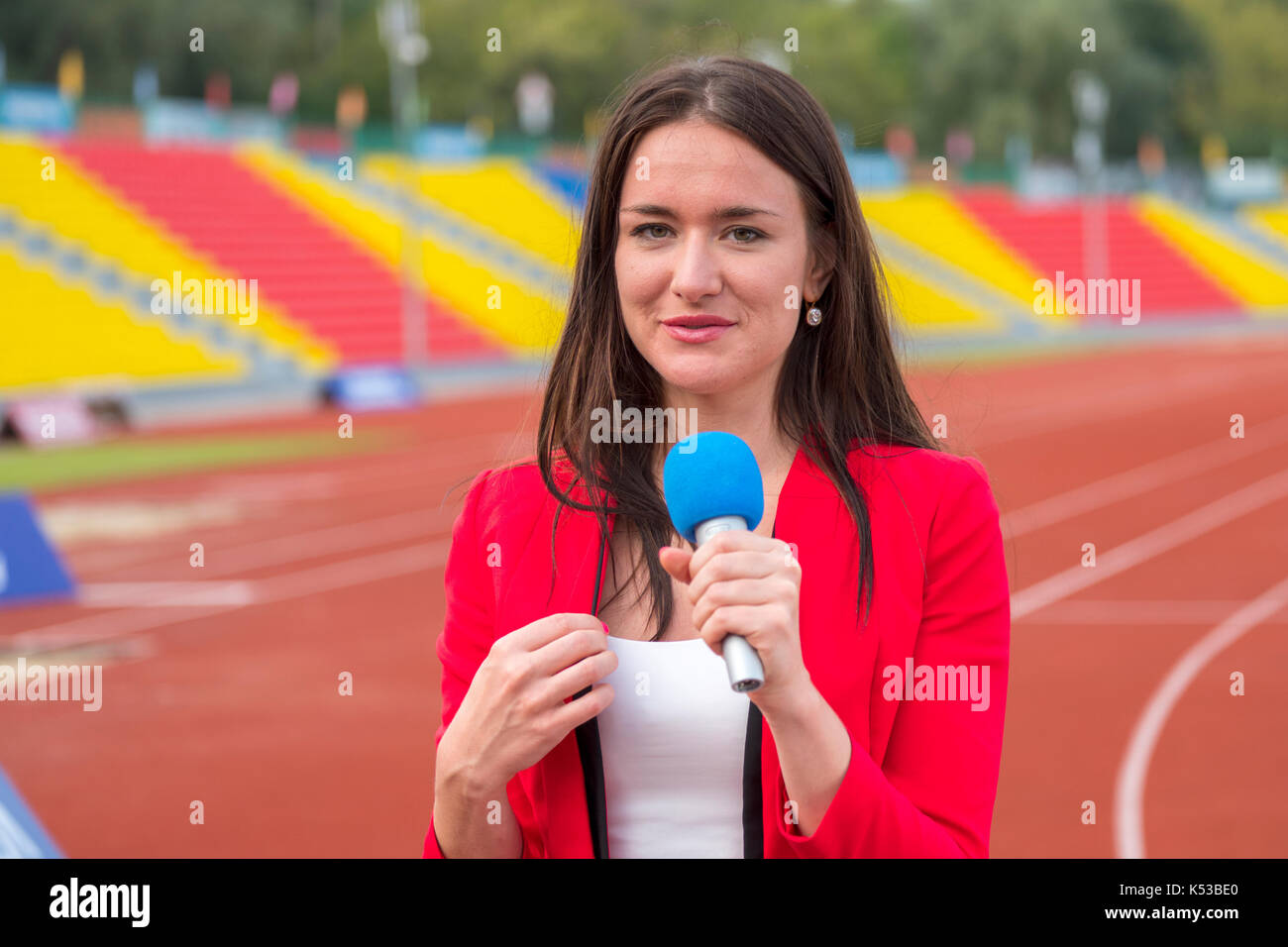 The journalist is reporting from the stadium for television Stock Photo ...