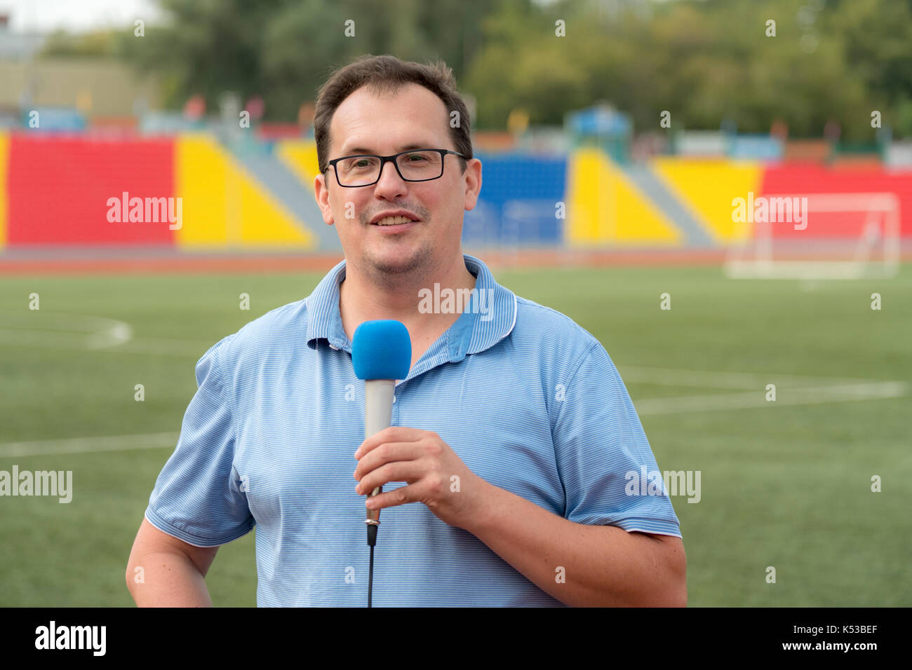 The journalist is reporting from the stadium for television Stock Photo ...