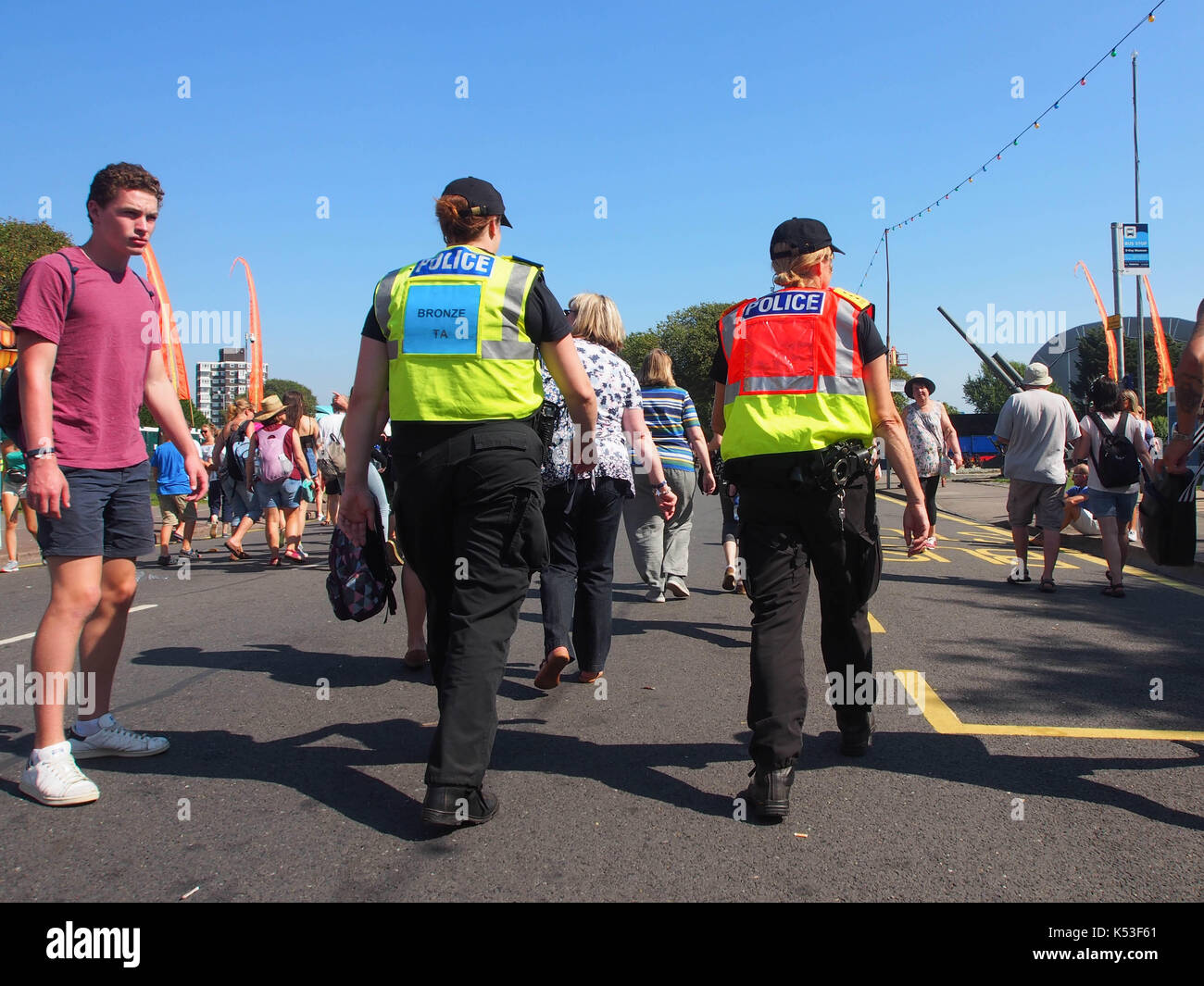Two police officers patrol on foot at an outdoor music festival Stock ...