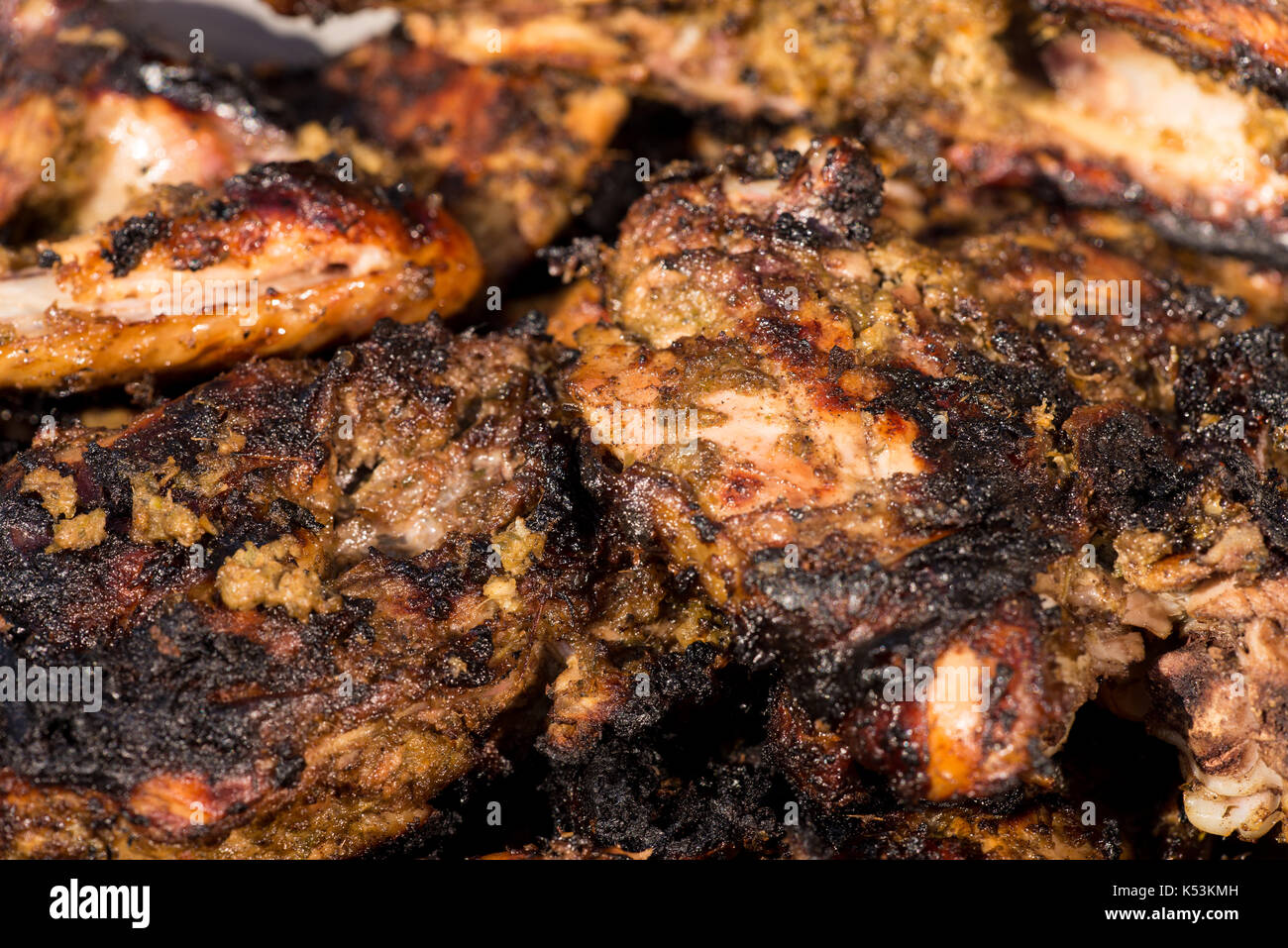 Closeup of grilled spicy jerk chicken cooked over wood fire Stock Photo ...