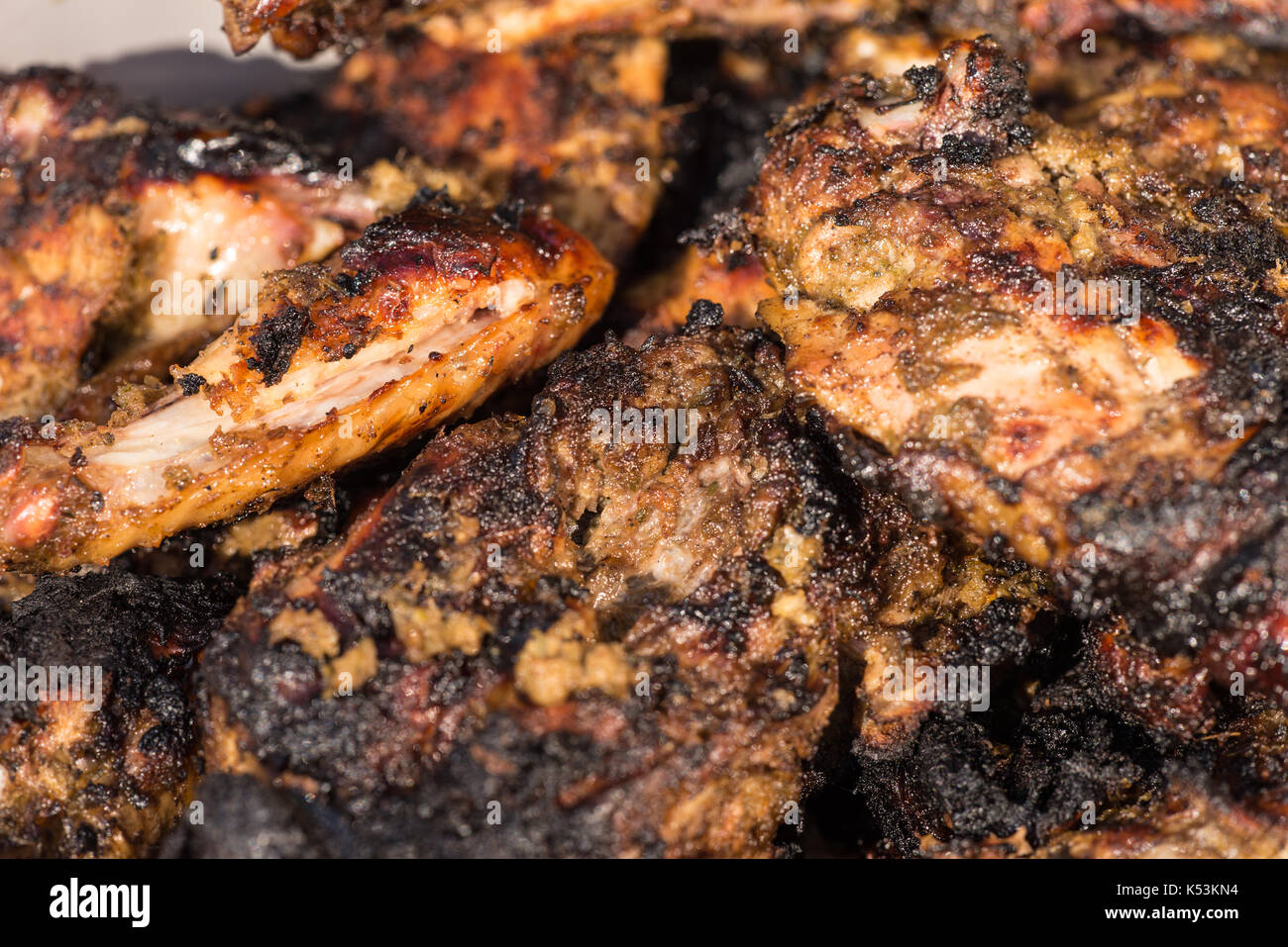 Closeup of grilled spicy jerk chicken cooked over wood fire Stock Photo ...